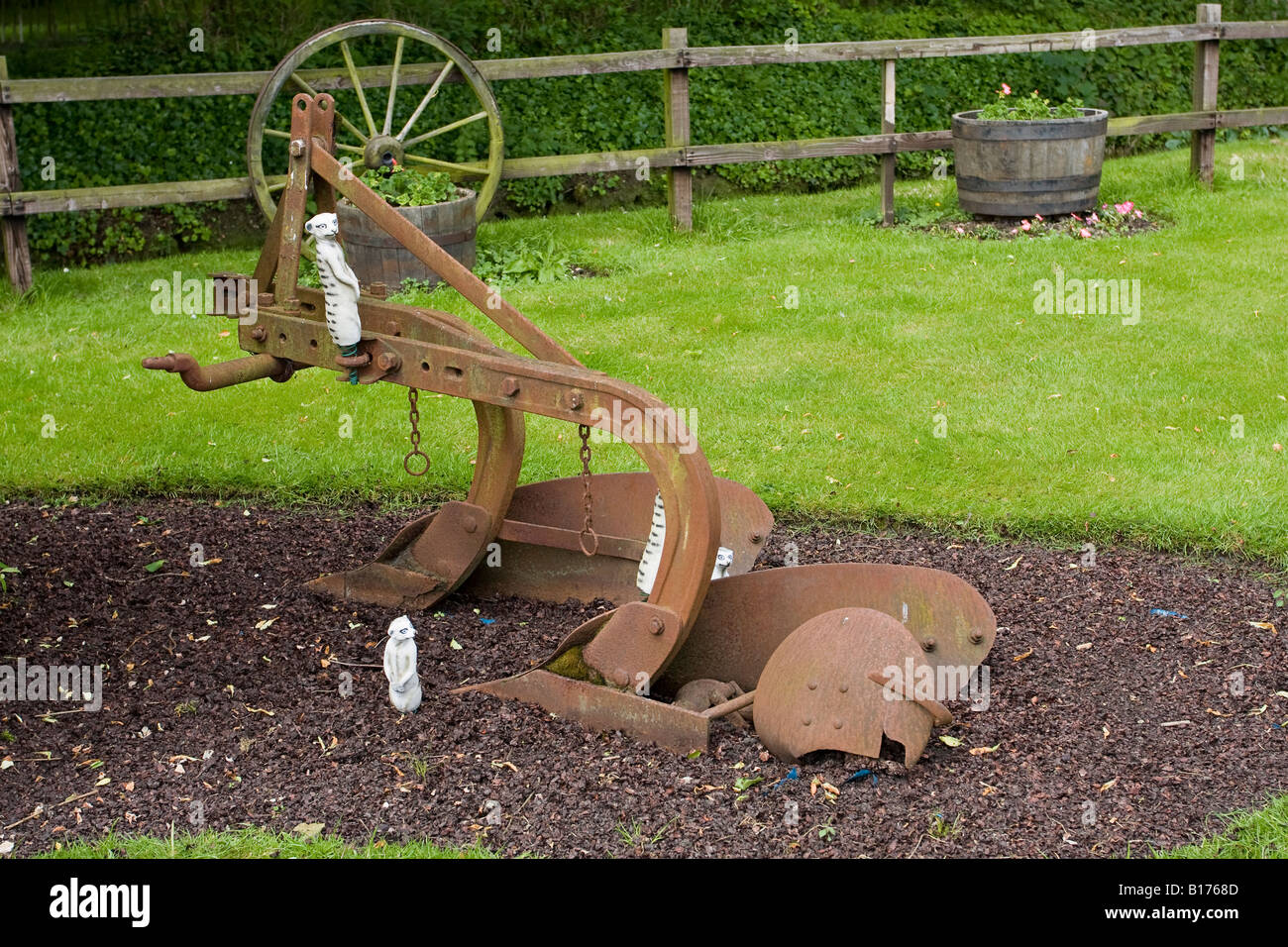 Rusty plough being used as a garden feature Stock Photo - Alamy