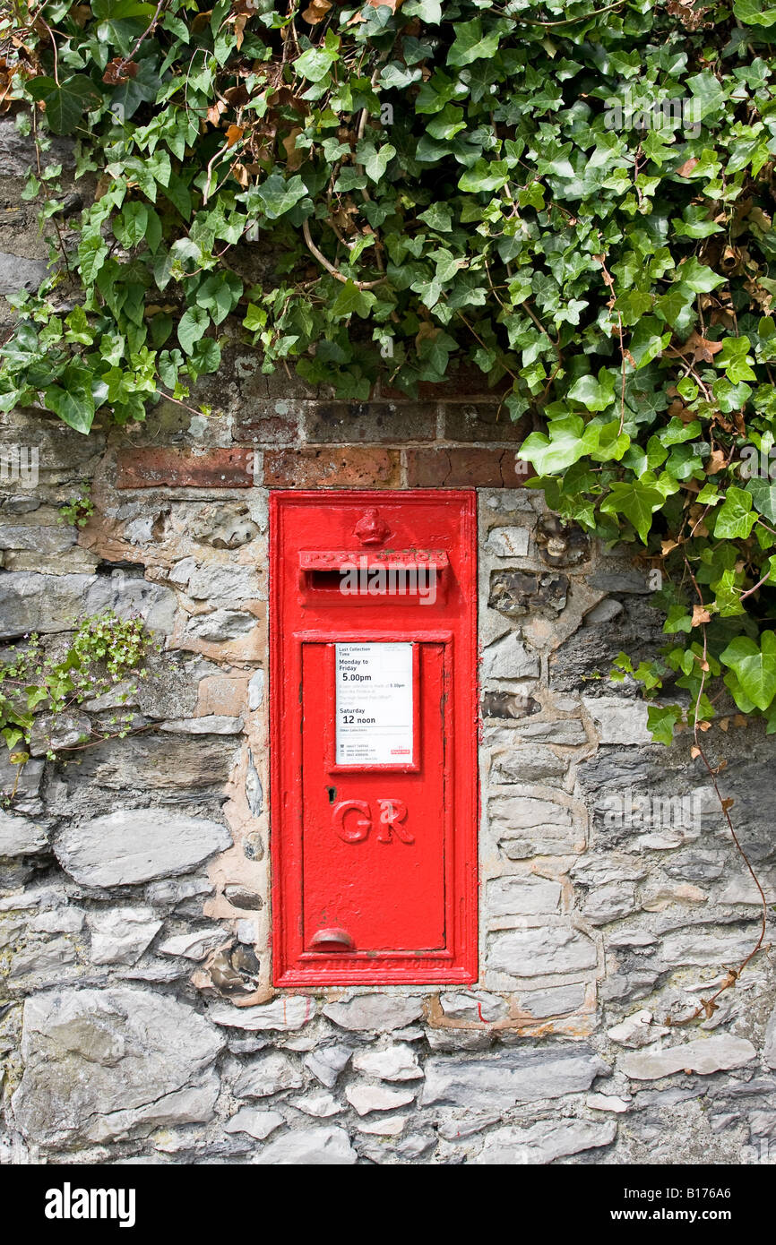 Red post box set into wall. Sussex, England, UK Stock Photo - Alamy