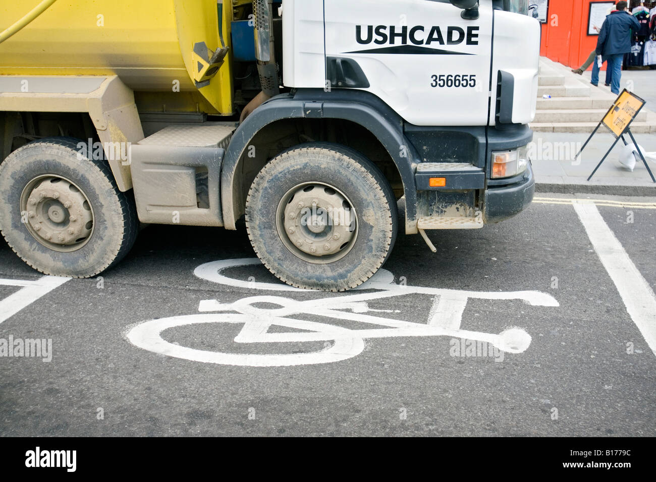a lorry queues in traffic at a traffic light in london with a cycle ...