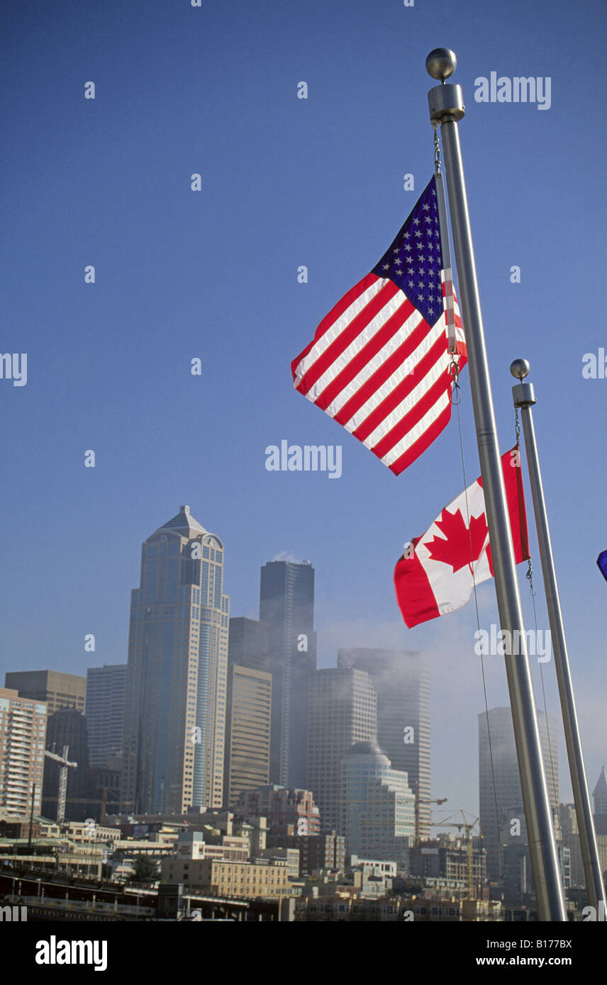 An American flag and a Canadian flag fly over the waterfront in ...