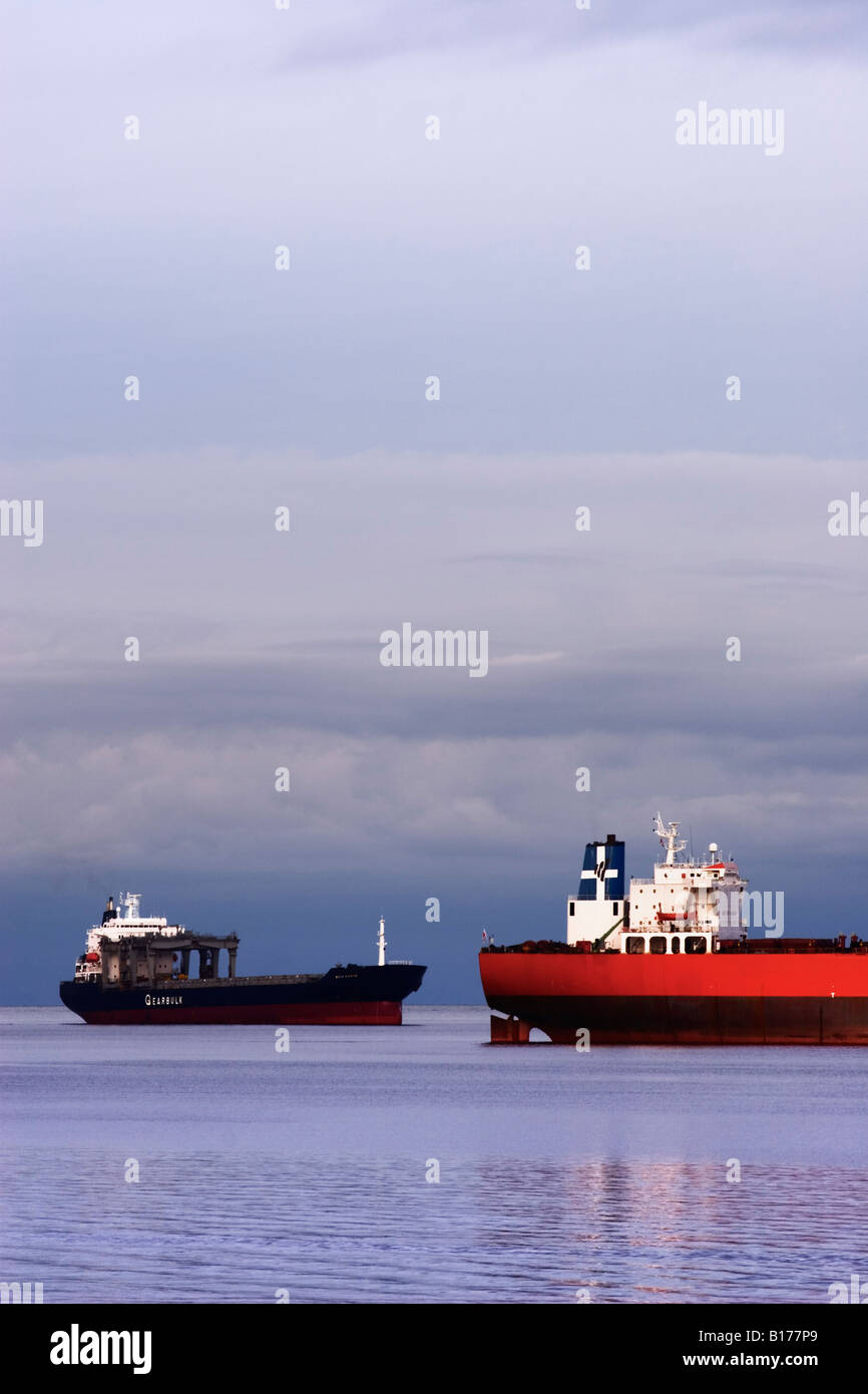 two cargo boats waiting at anchor vancouver Stock Photo - Alamy