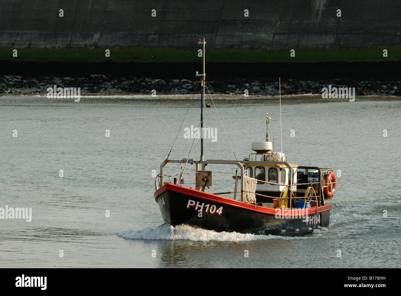 Fishing boat entering Aberystwyth harbour Stock Photo - Alamy