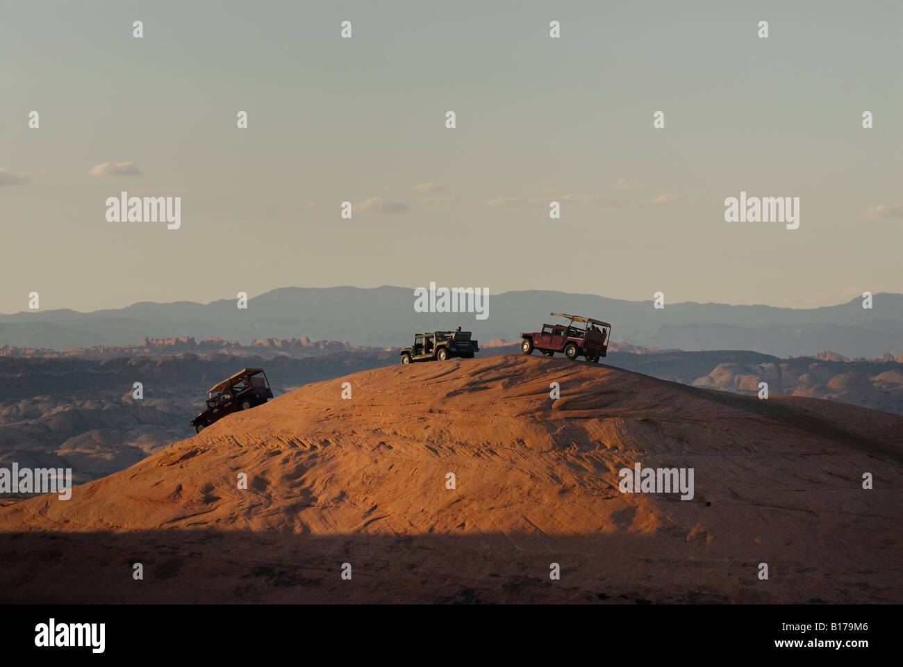 Hummer jeeps on the slick rock trail near Moab Utah at sunset USA Stock ...