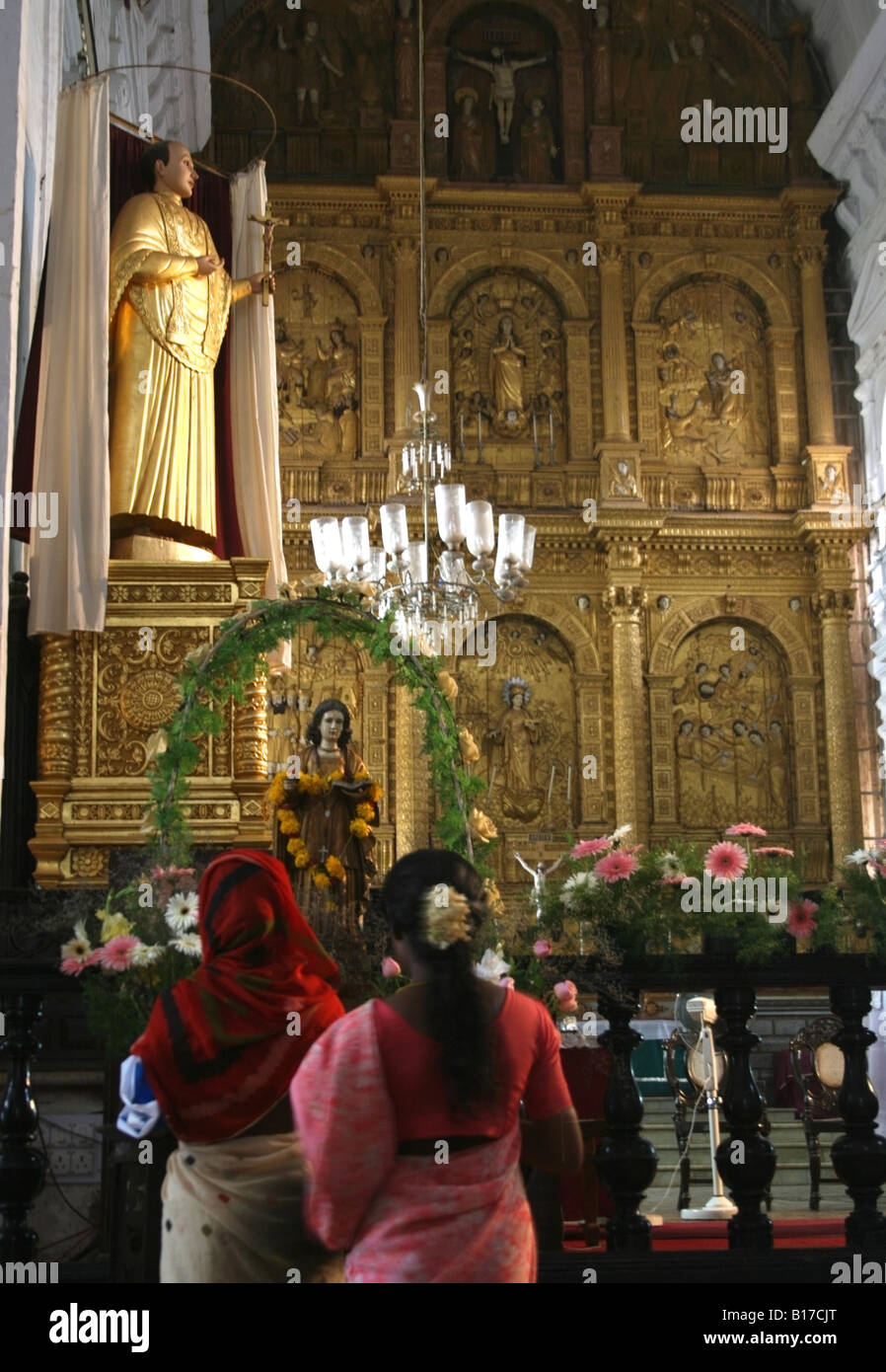 Indian Christians worship at the main altar of Se Cathedral depicting ...
