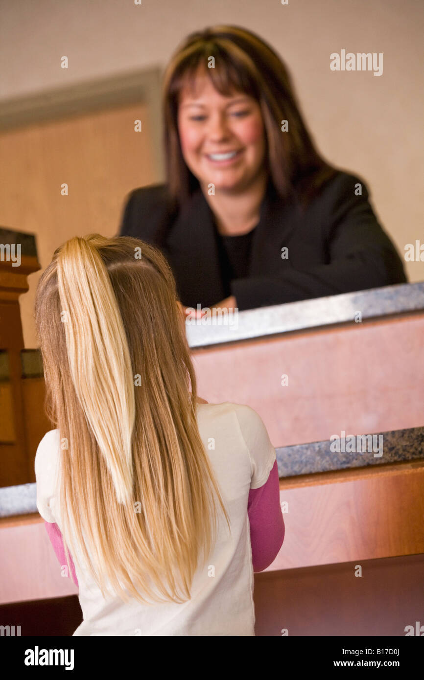 Girl at service desk Stock Photo - Alamy