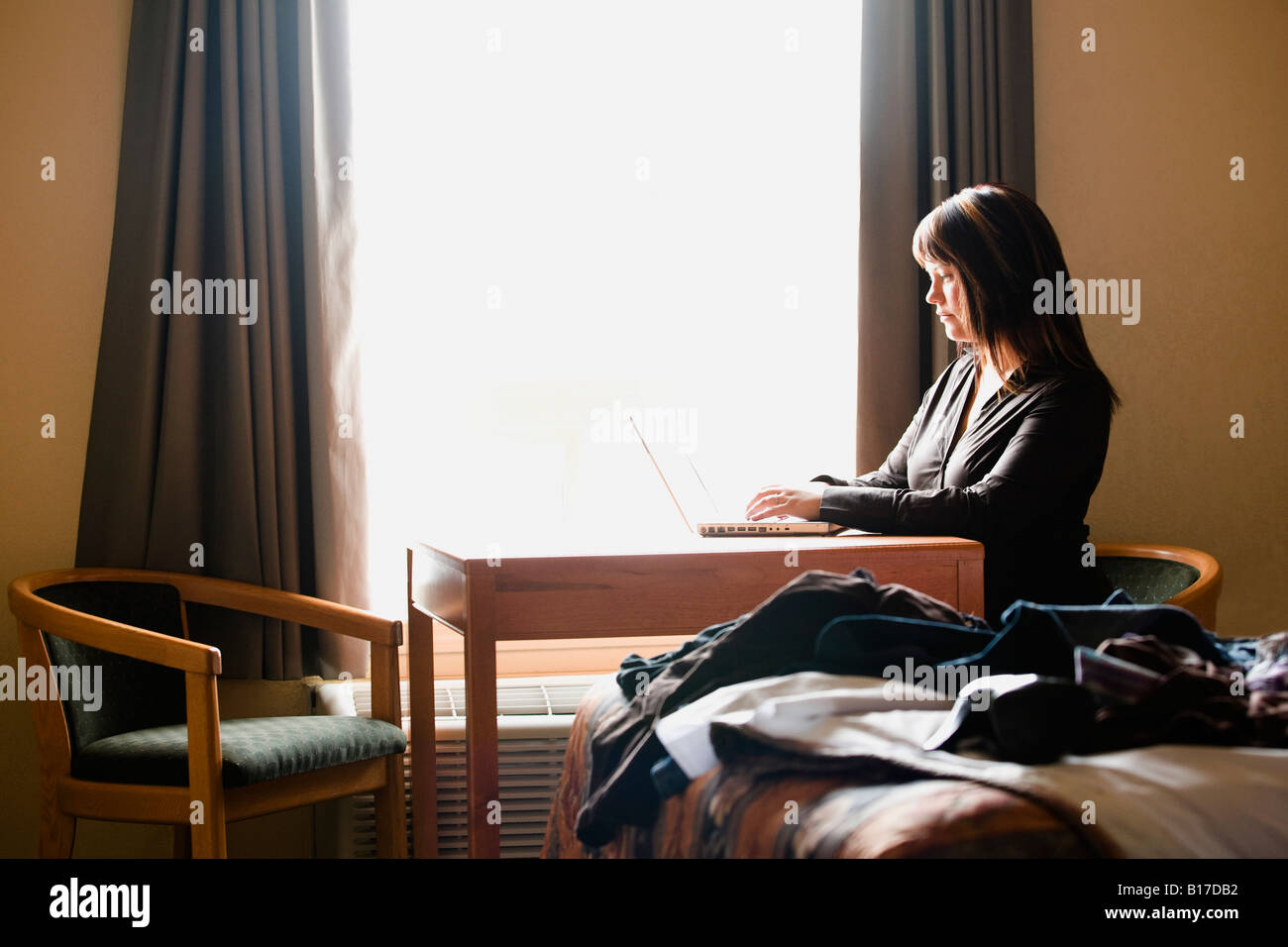 Woman working on computer in hotel room Stock Photo - Alamy