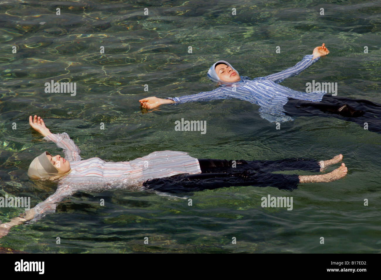 Two girls floating in the sea hi-res stock photography and images - Alamy