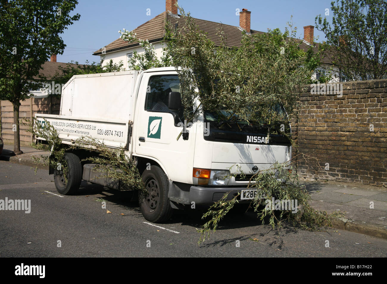 Gardeners van with twigs hung on the side Stock Photo - Alamy