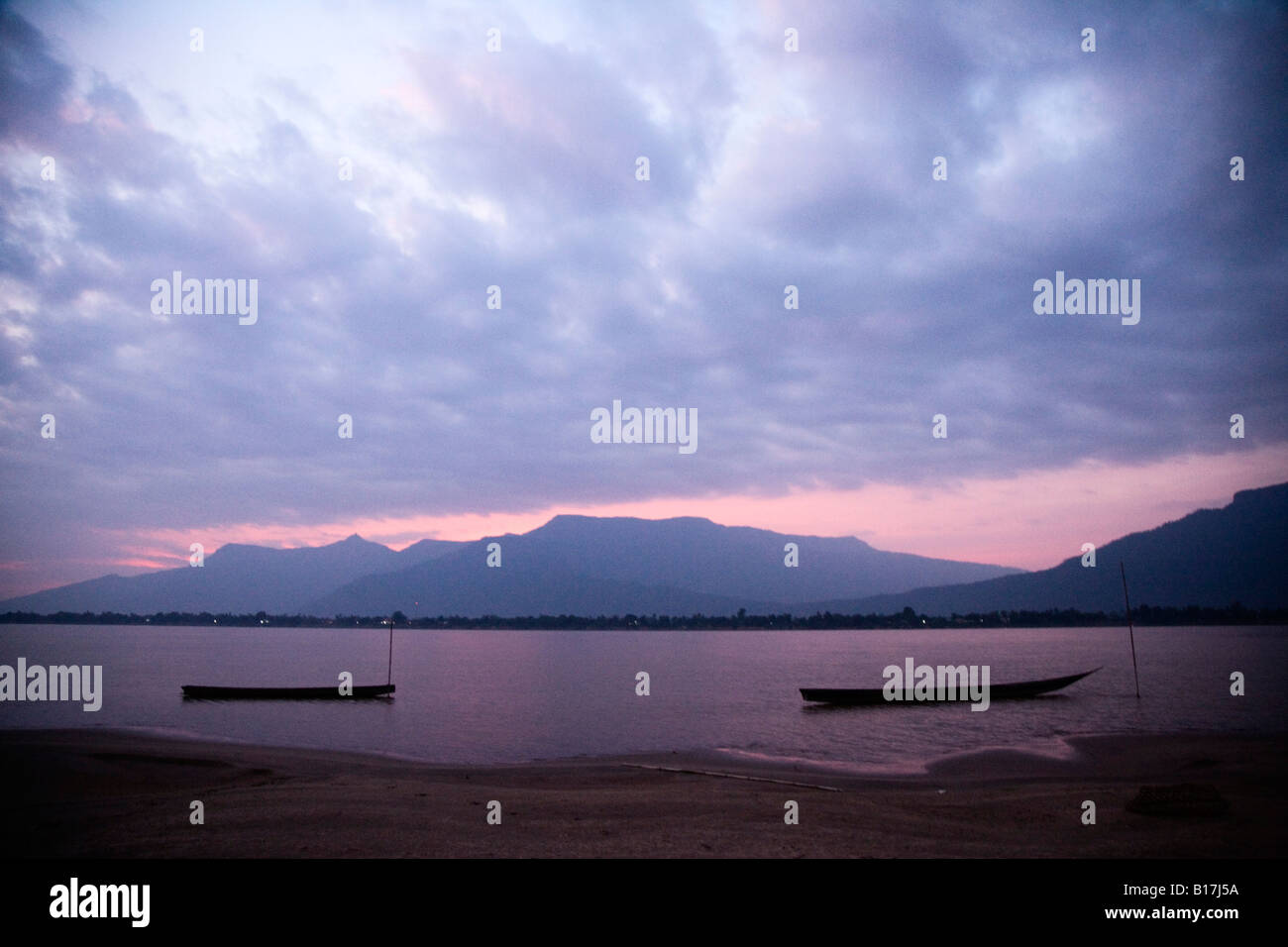Two boats on the Mekong River at sunset, Don Daeng island, southern ...