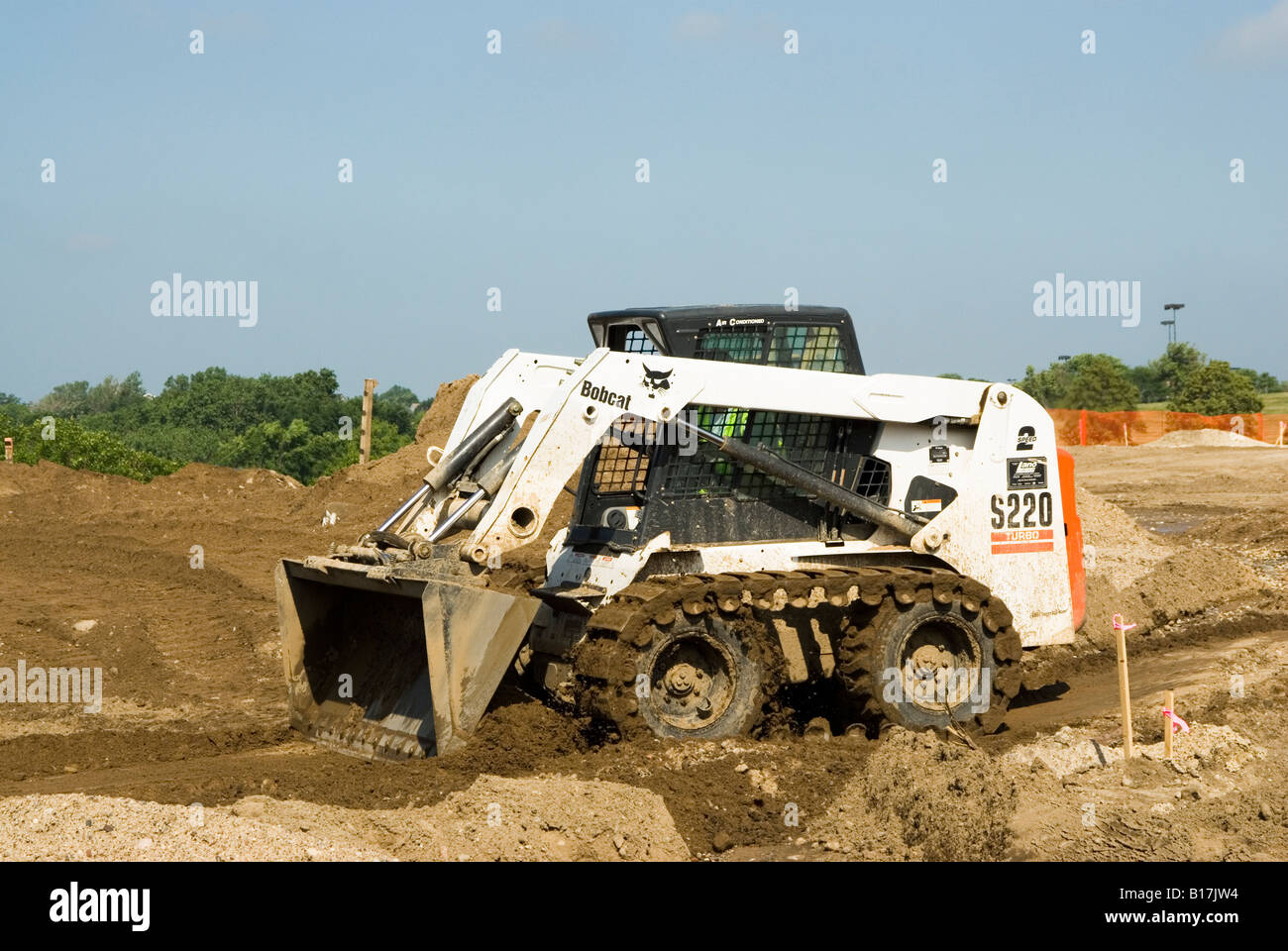 a bobcat skid loader at work on a consturction site Stock Photo - Alamy
