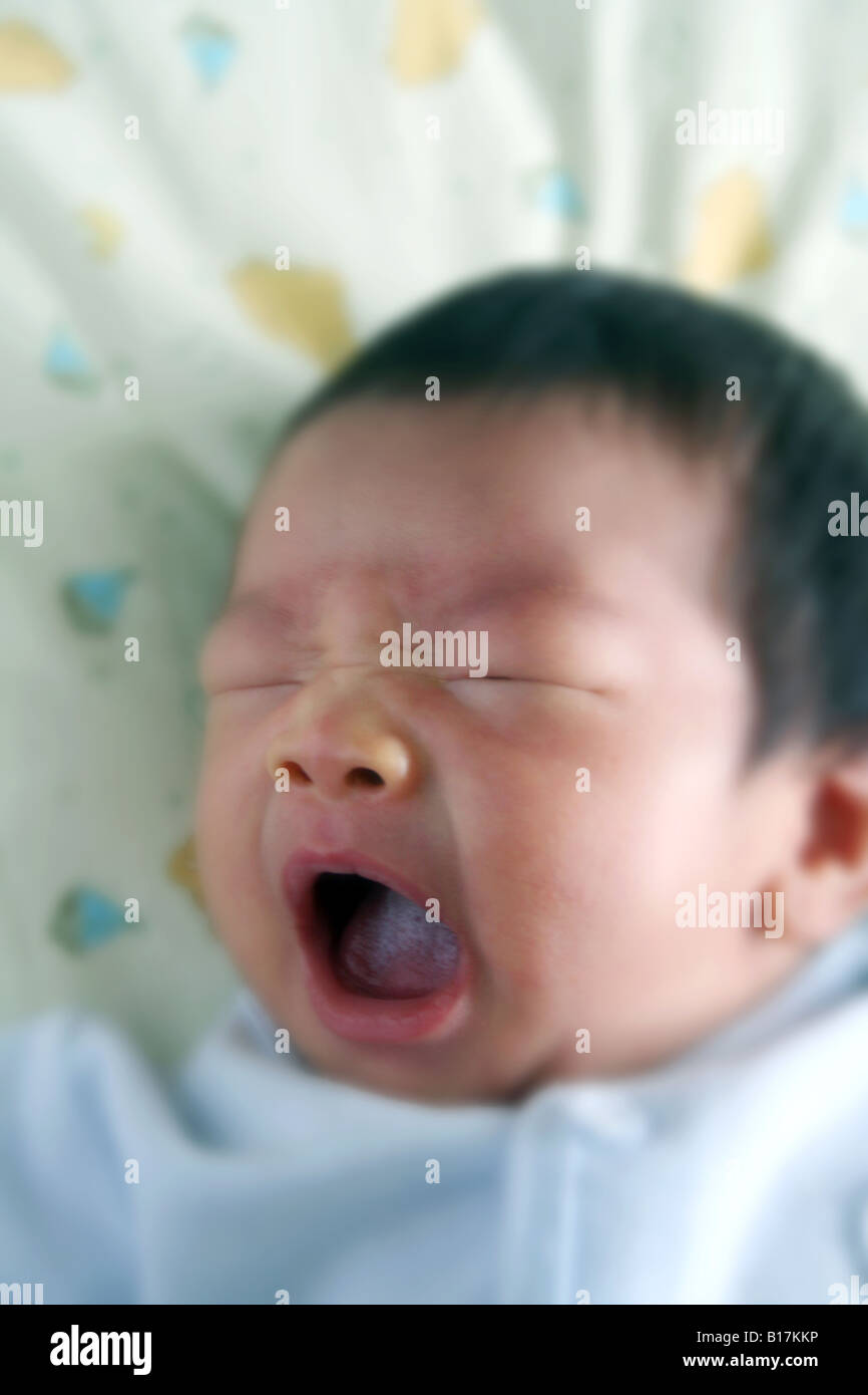 Baby yawning facial expression Stock Photo - Alamy