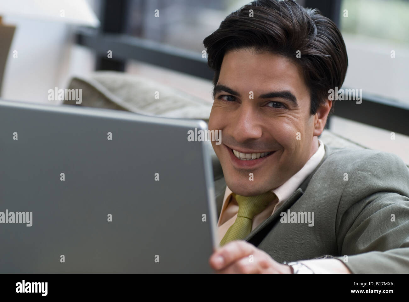 Hispanic businessman holding laptop Stock Photo - Alamy