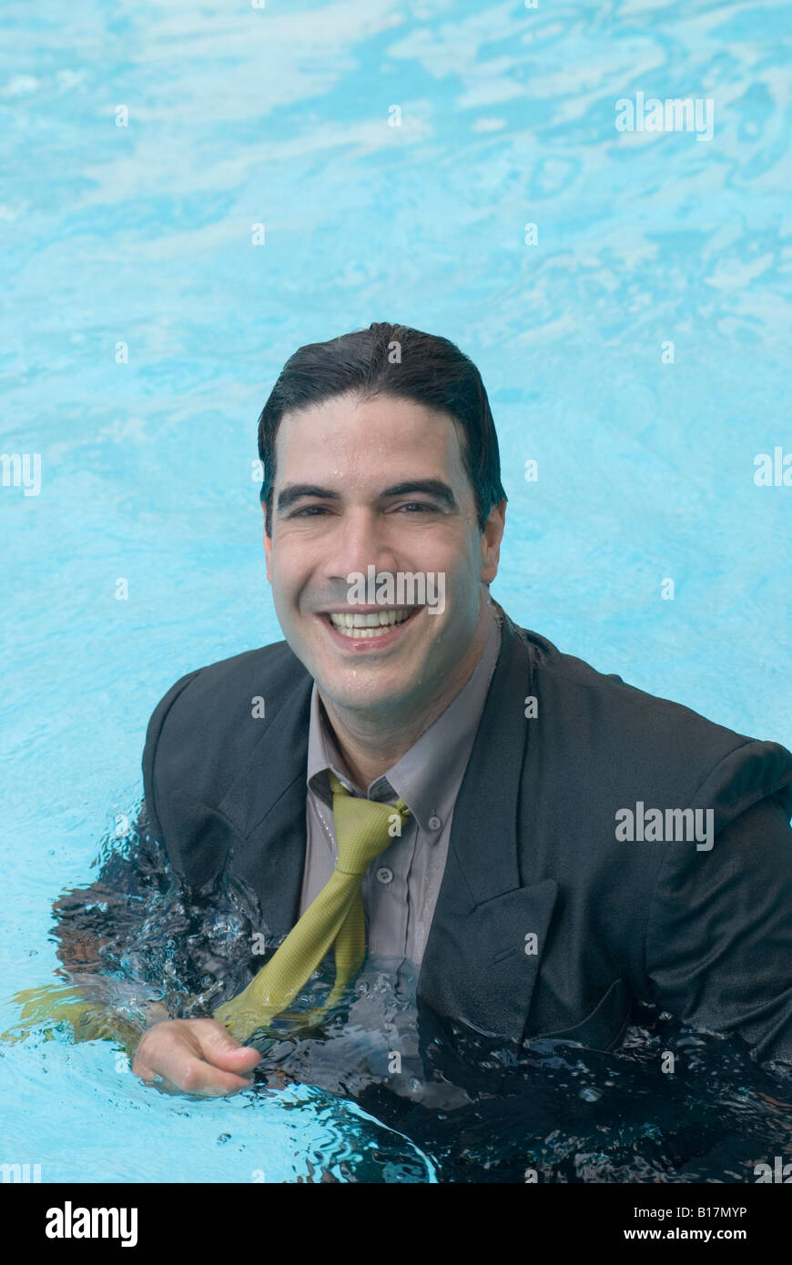 Hispanic businessman in swimming pool Stock Photo - Alamy