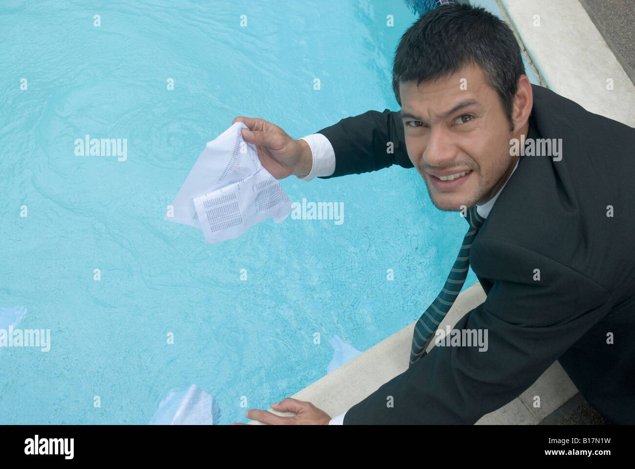 Hispanic businessman holding wet paperwork Stock Photo - Alamy