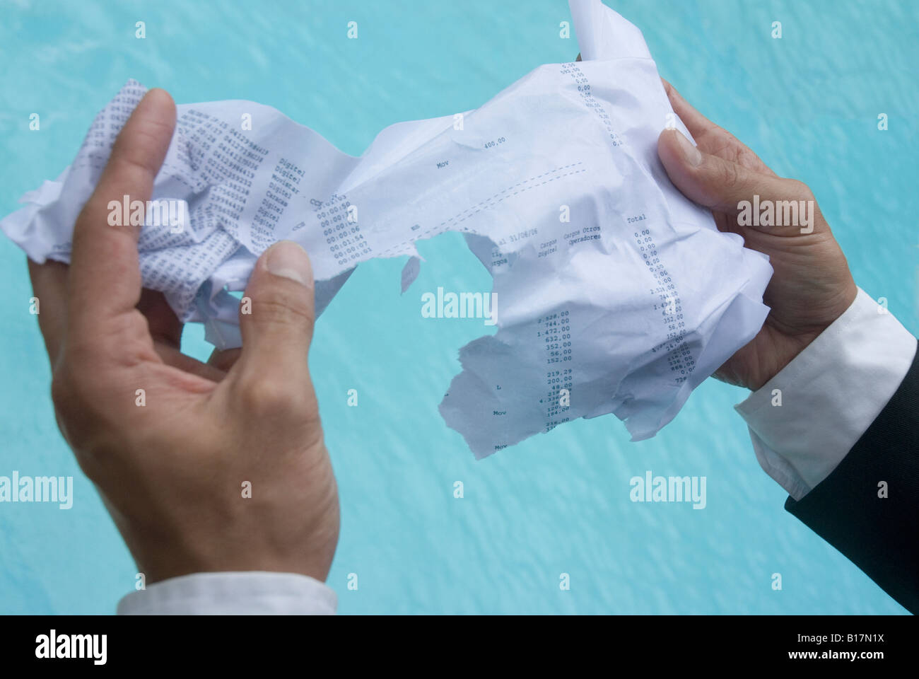 Hispanic businessman holding wet paperwork Stock Photo - Alamy