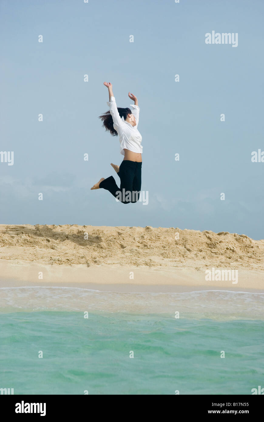 Woman jumping at beach Stock Photo - Alamy