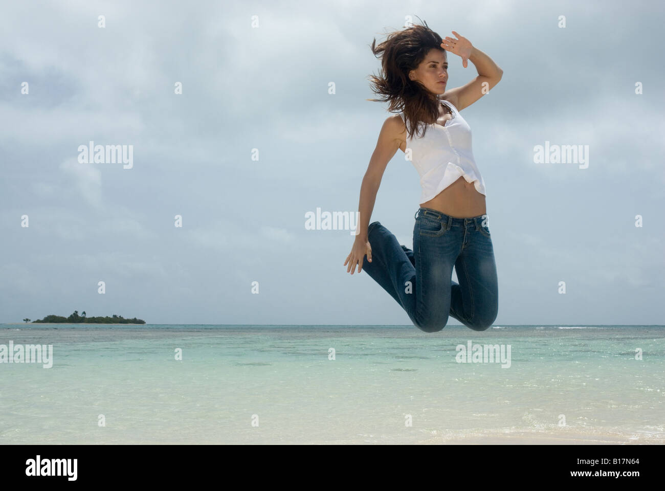 Woman jumping at beach Stock Photo - Alamy