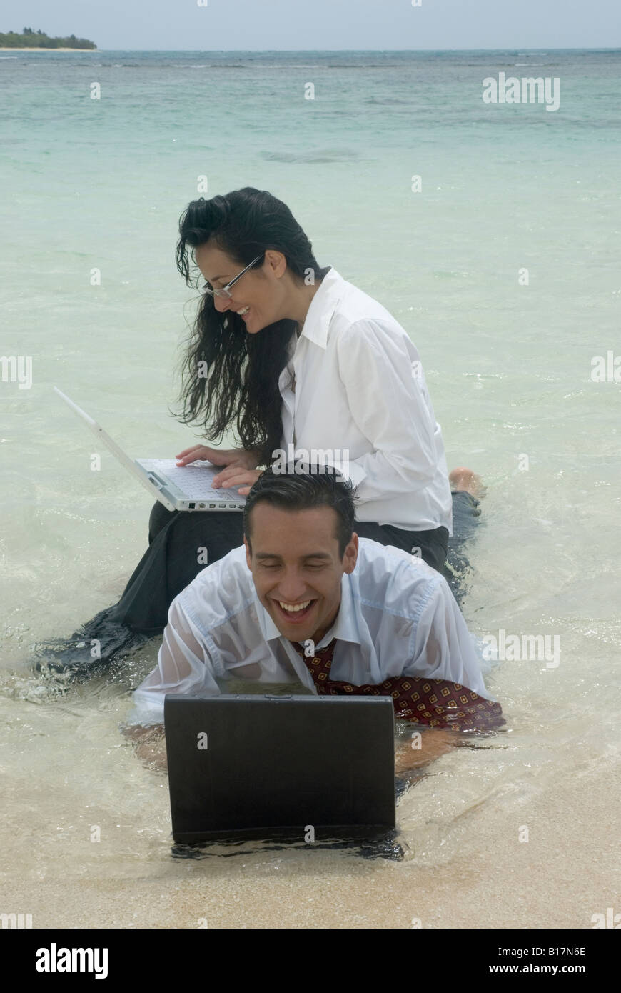 Hispanic businesspeople working in water Stock Photo - Alamy