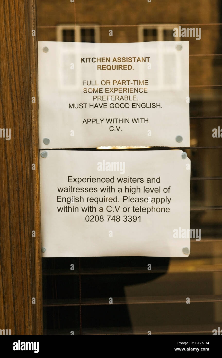 England, London, Hammersmith, Help wanted sign on window glass of ...