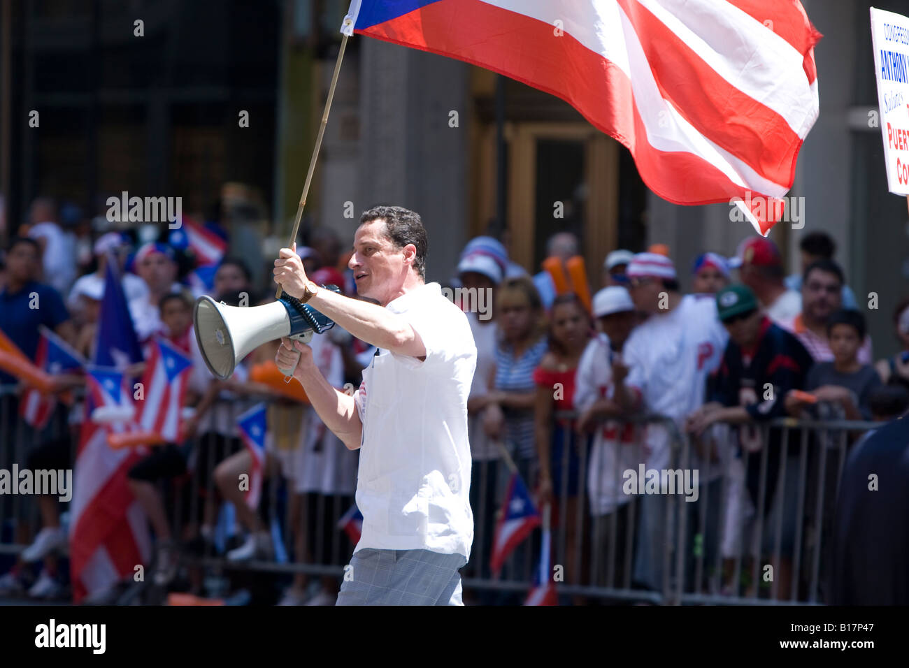 Congressman Anthony Weiner waves a Puerto Rican flag as he shouts in a ...