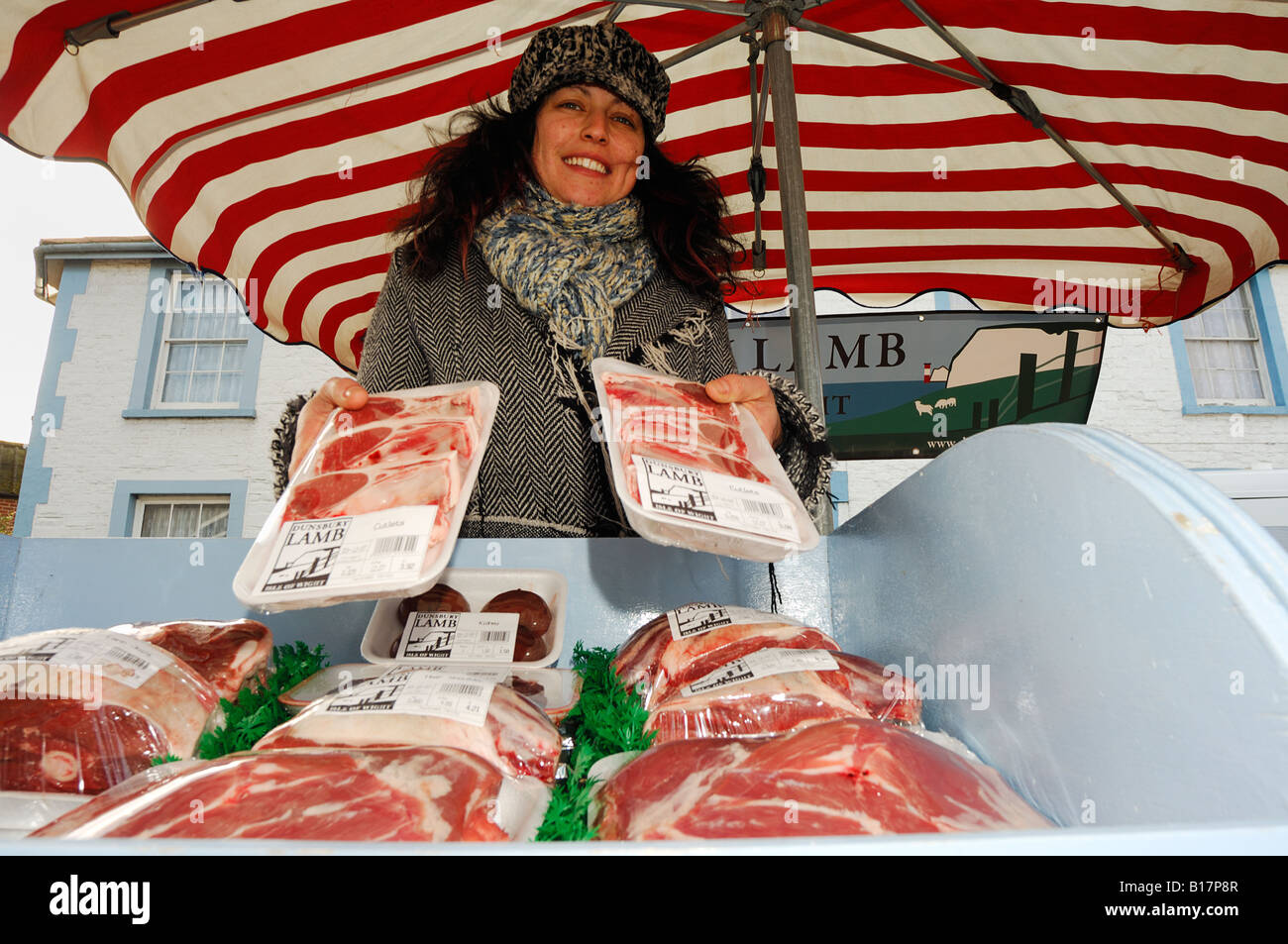 A girl selling lamb at a farmer's market Stock Photo - Alamy