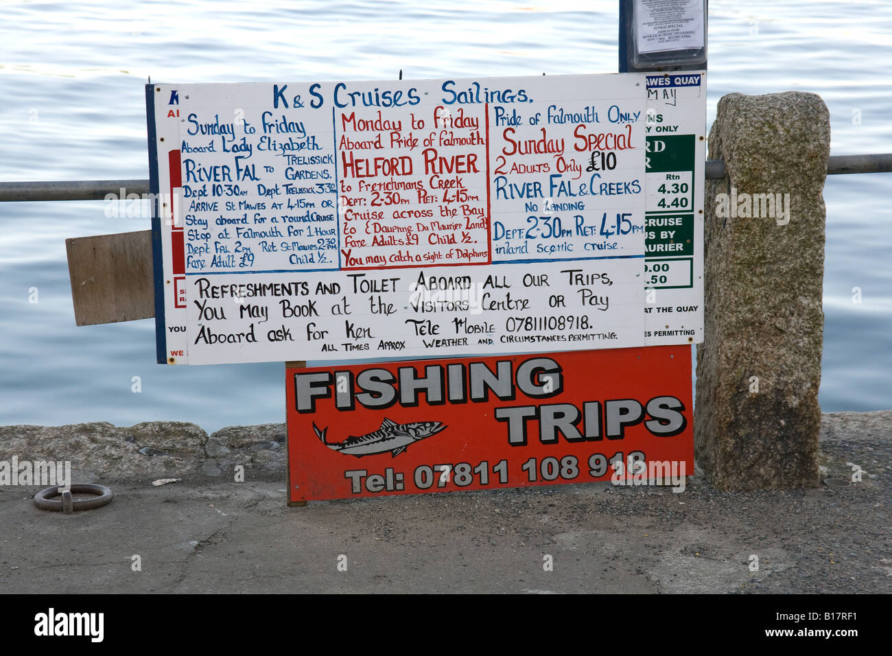 Fishing trip sign and ferry listings St Mawes Cornwall England Stock ...
