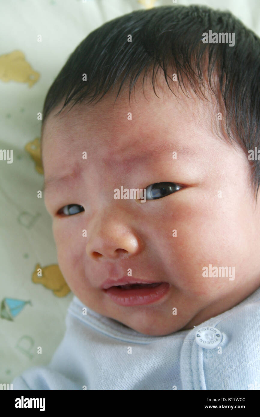 Facial expression of baby crying Stock Photo - Alamy