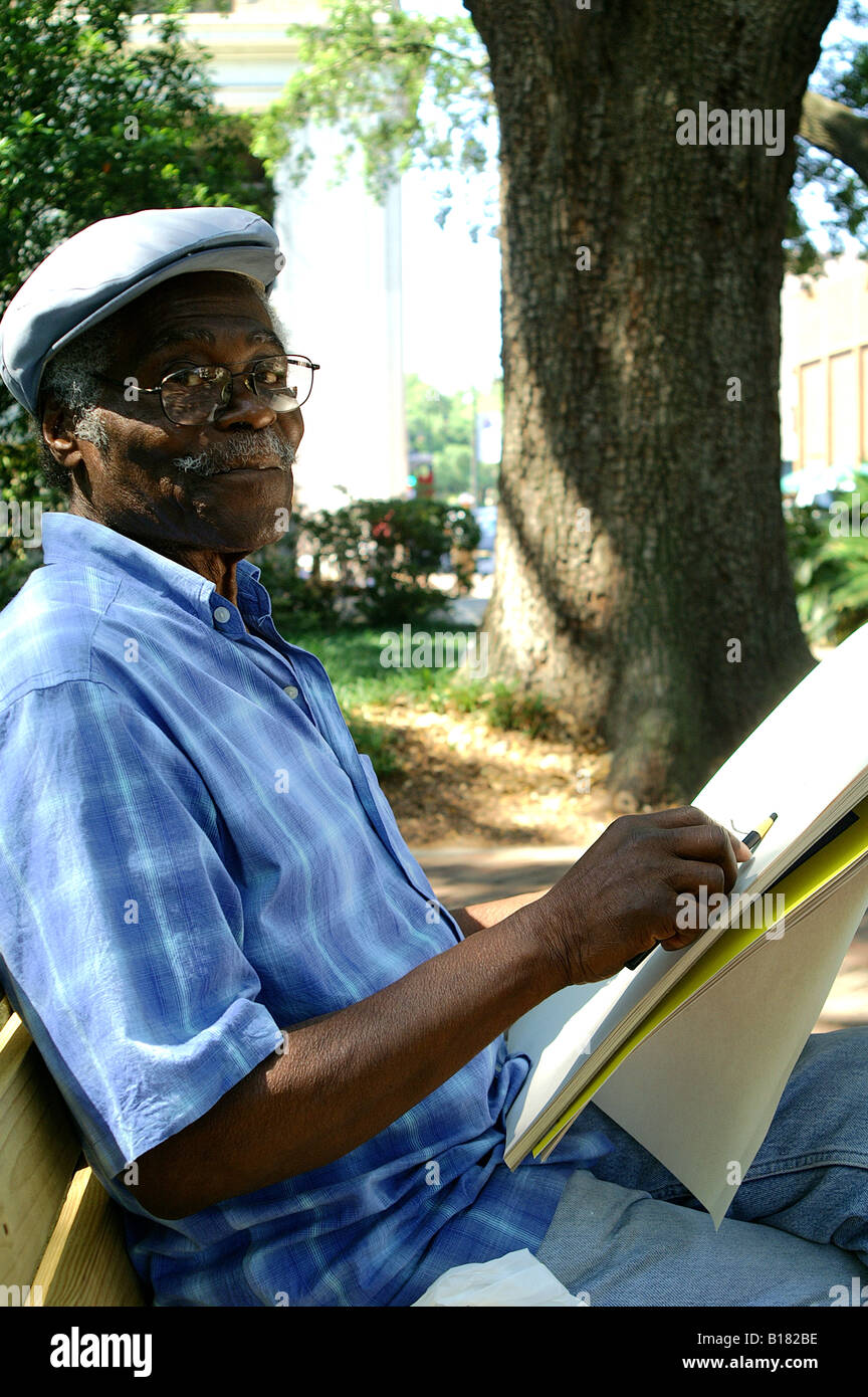 Man with sketch pad, smiling Stock Photo - Alamy