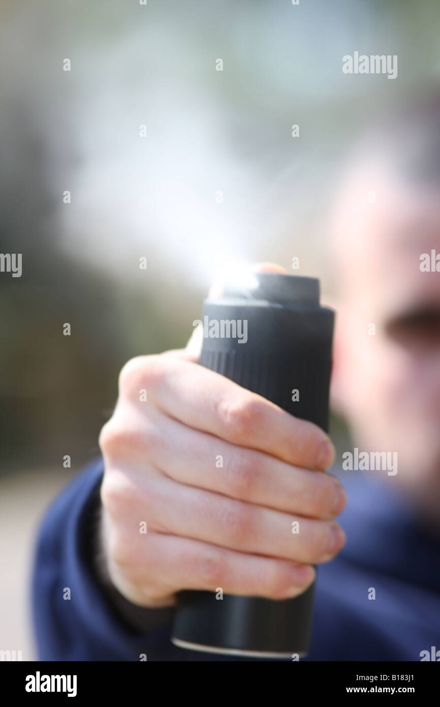 Man Spraying CS Gas Model Released Stock Photo - Alamy