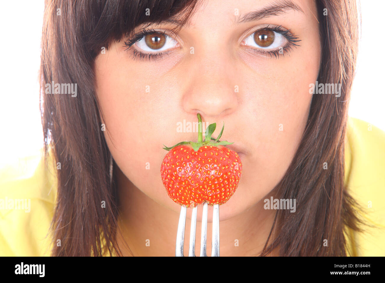 Young Woman Eating a Strawberry Model Released Stock Photo - Alamy