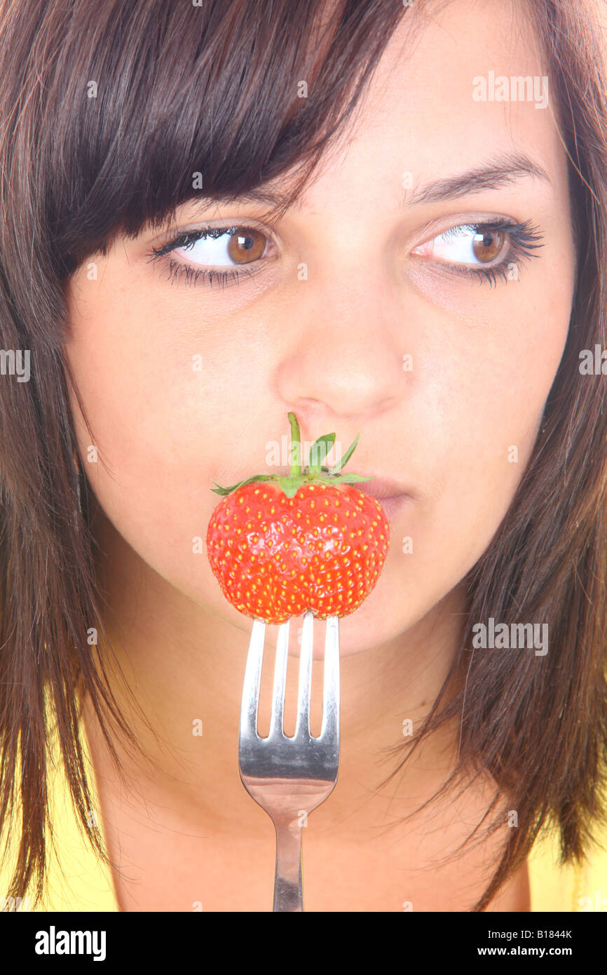 Young Woman Eating a Strawberry Model Released Stock Photo - Alamy