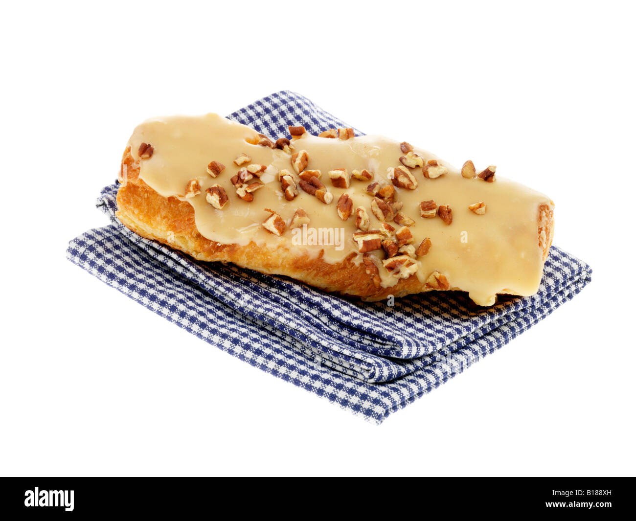 Single Walnut And Butterscotch Iced Pastry Twist Isolated Against A ...