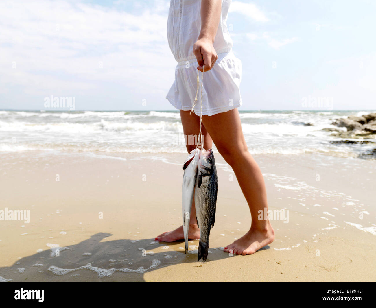 Young Woman Holding Fish Model Released Stock Photo - Alamy