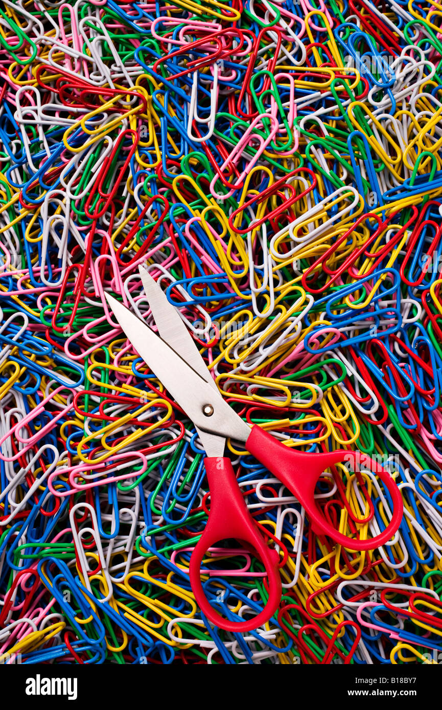 Red handled scissors on paperclips Stock Photo - Alamy