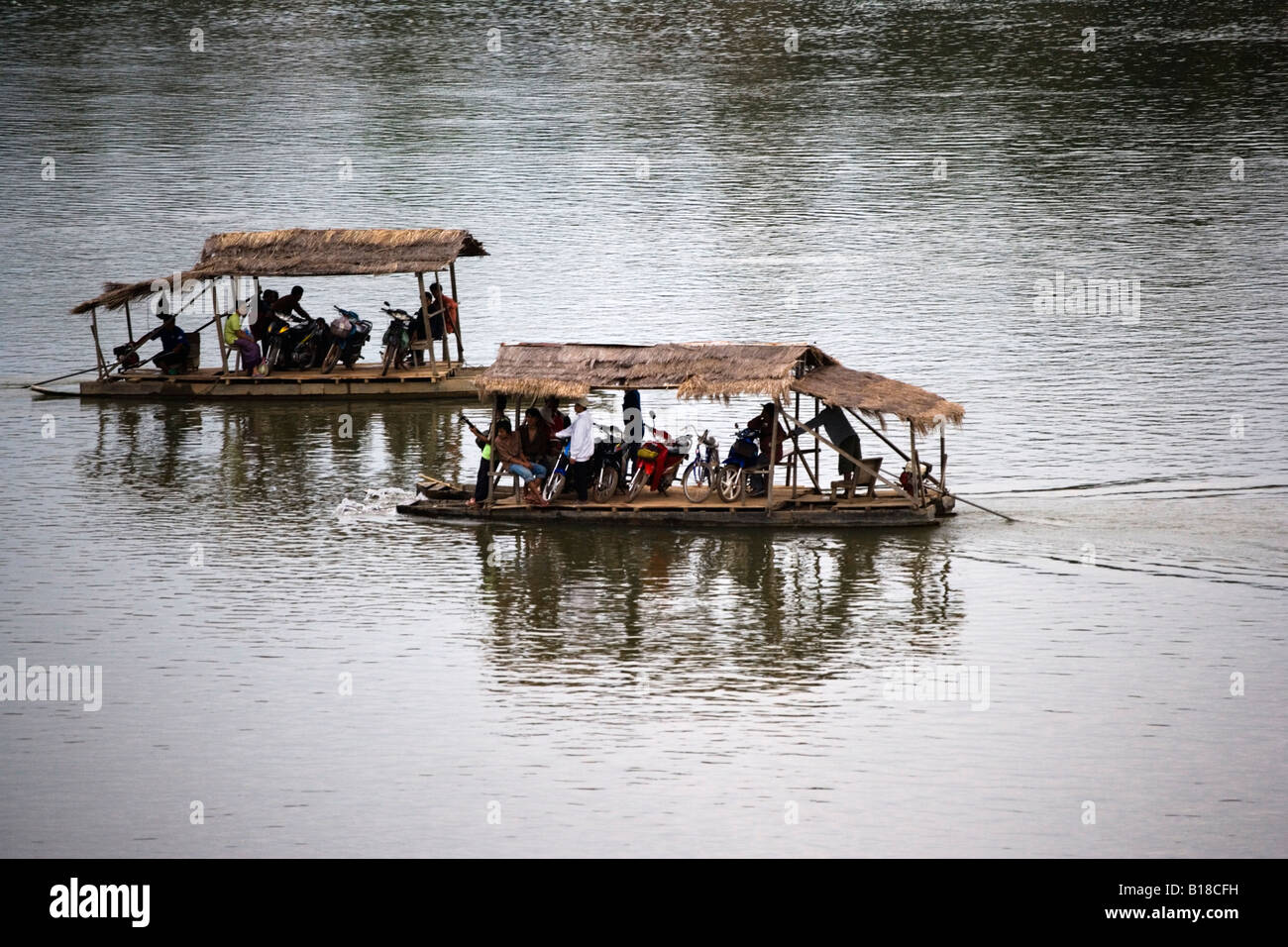 Wooden ferries pass each other on the Sekong River, Attapeu, Laos Stock ...