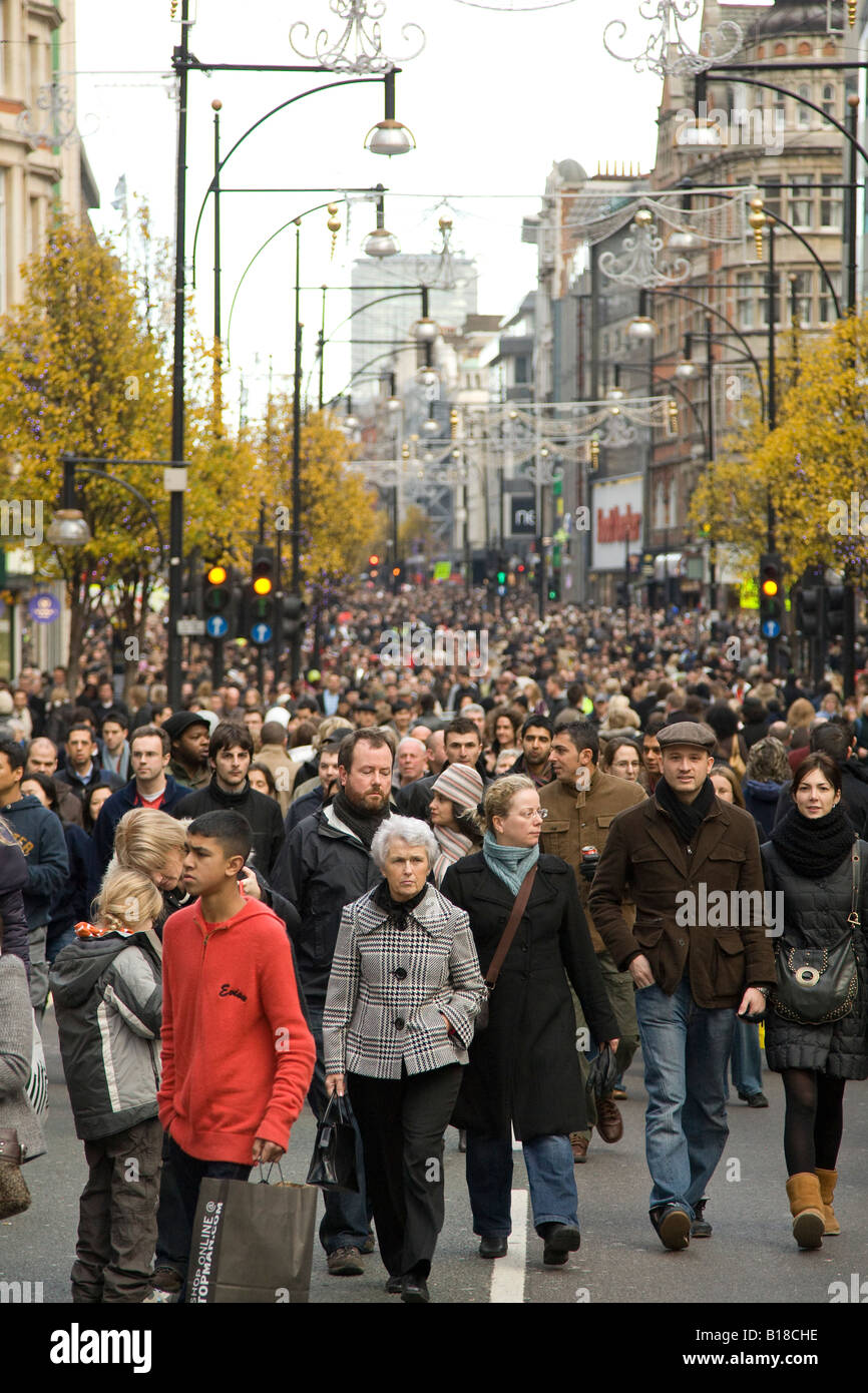 A crowd of shoppers make their way down Oxford Street in London a few ...