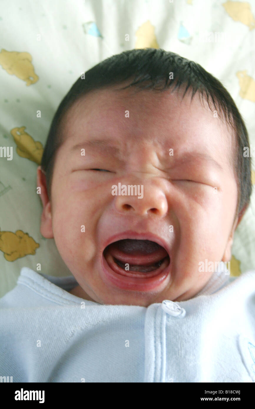 Facial expression of baby crying Stock Photo - Alamy