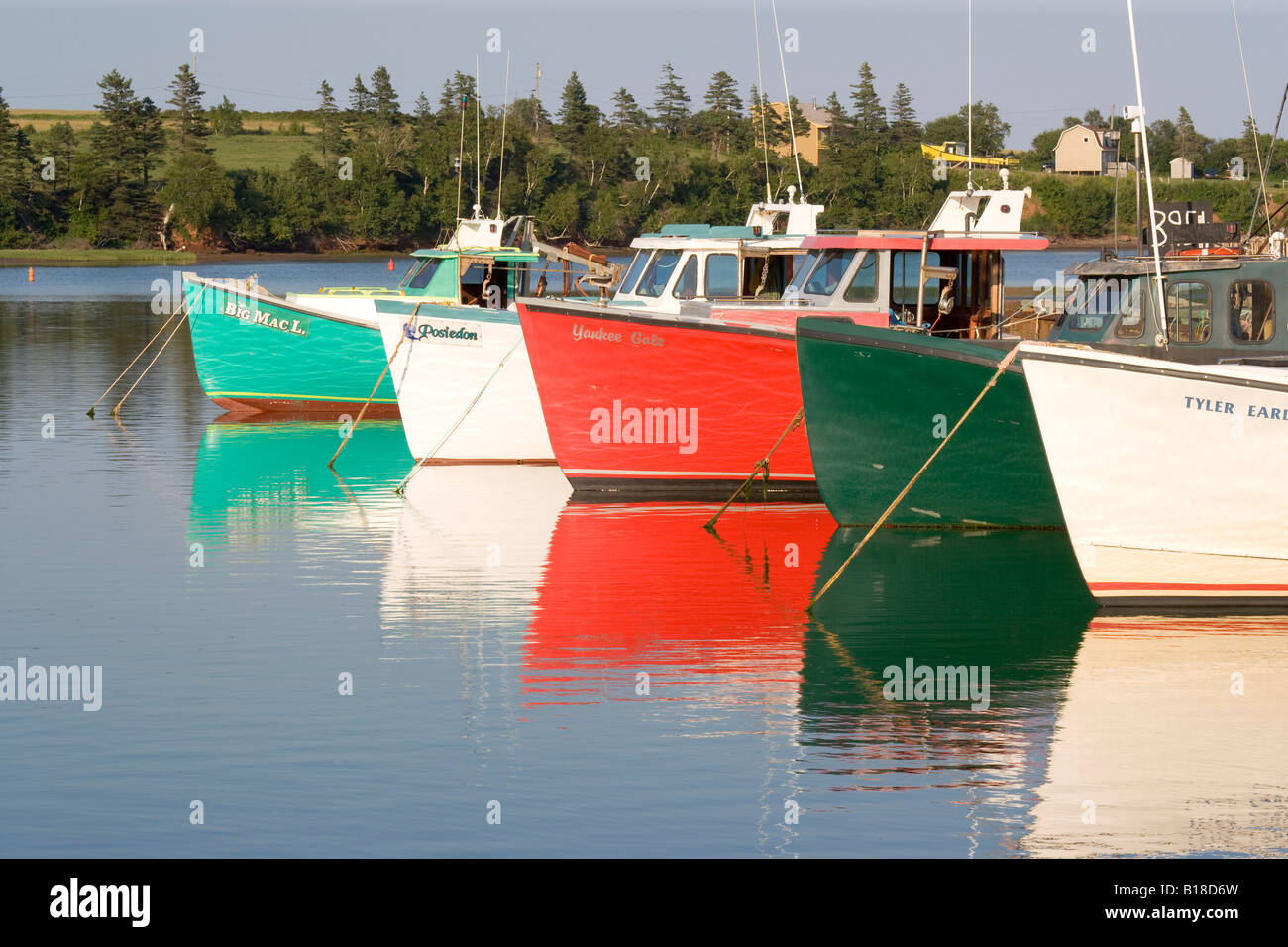 Fishing boats reflected in French River harbour, Prince Edward Island ...