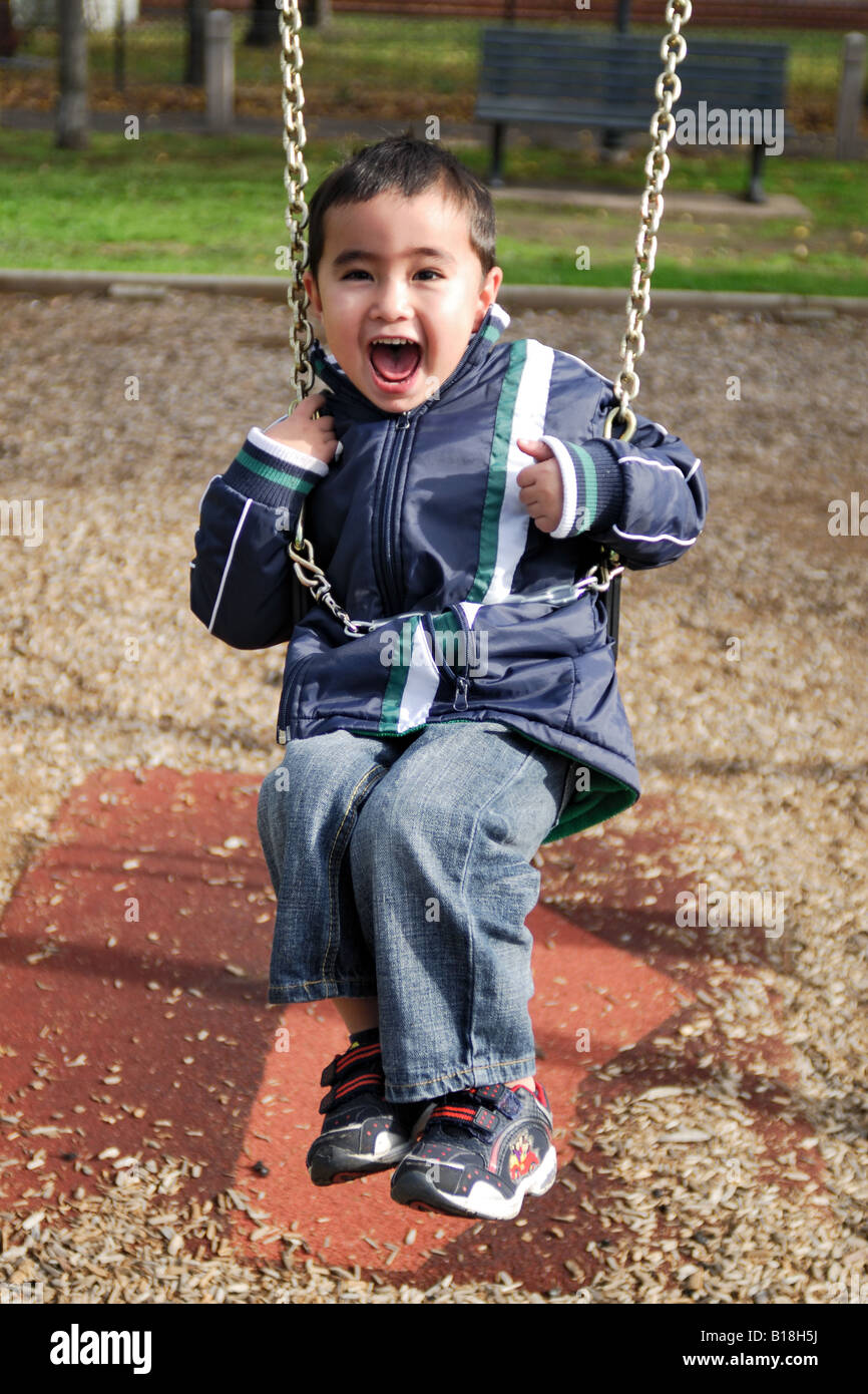 Boy on a swing Stock Photo - Alamy