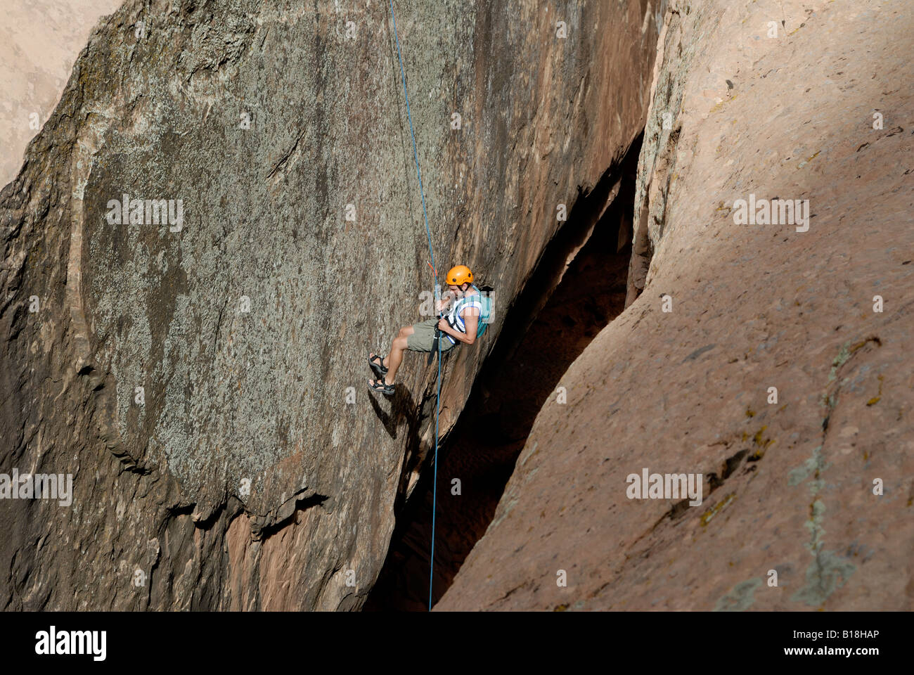 Tourist hanging on a rope while Canyoning in the area of the slick rock ...