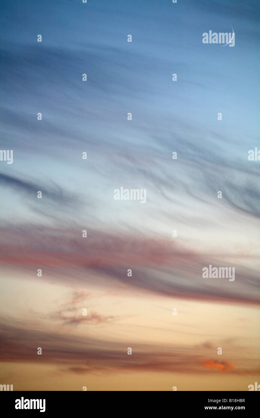 colored evening sky with cirrus clouds and the moon Stock Photo - Alamy