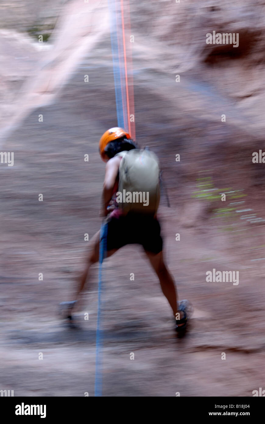 Tourist hanging on a rope while Canyoning in the area of the slick rock ...