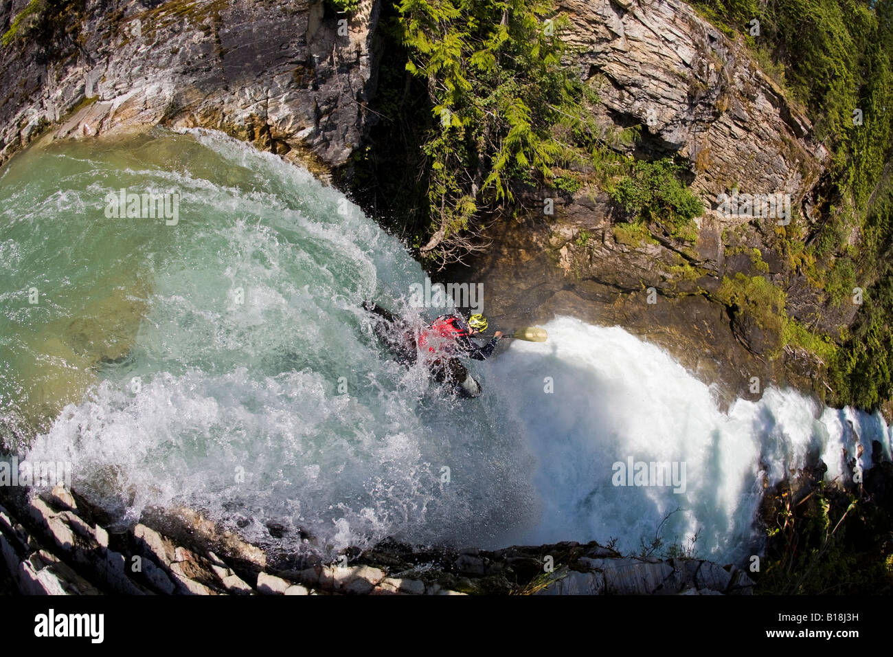 A kayaker running the 60 foot Sutherland Falls, Revelstoke, British ...