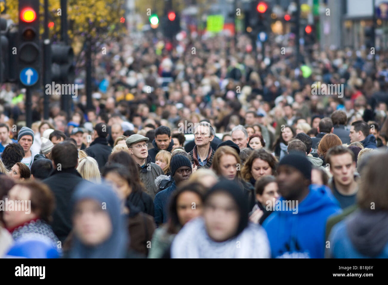 A crowd of shoppers make their way down Oxford Street in London a few ...