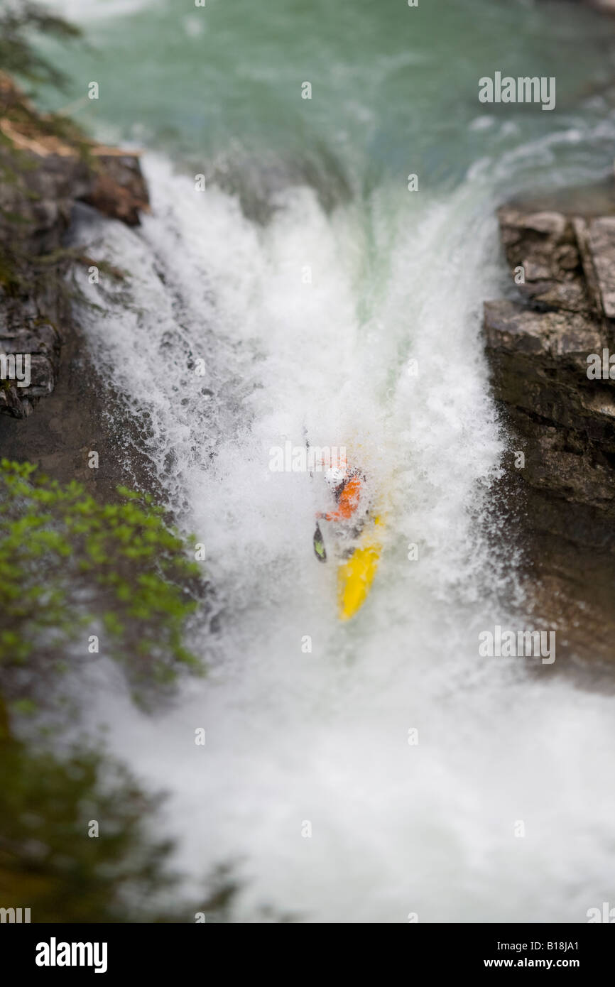 A kayaker running the classic waterfall run of Johnston Canyon, Banff ...
