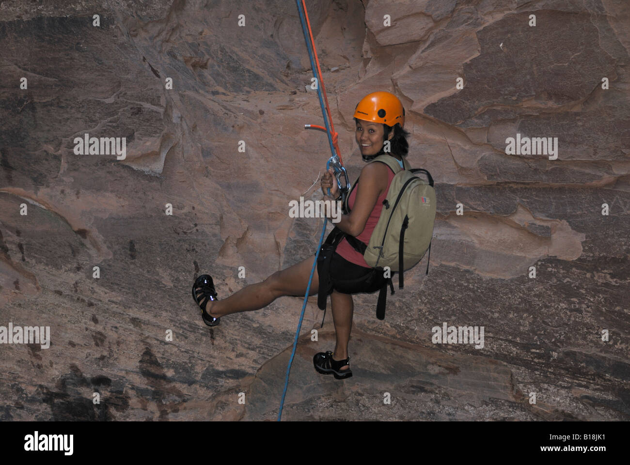 Tourist hanging on a rope while Canyoning in the area of the slick rock ...