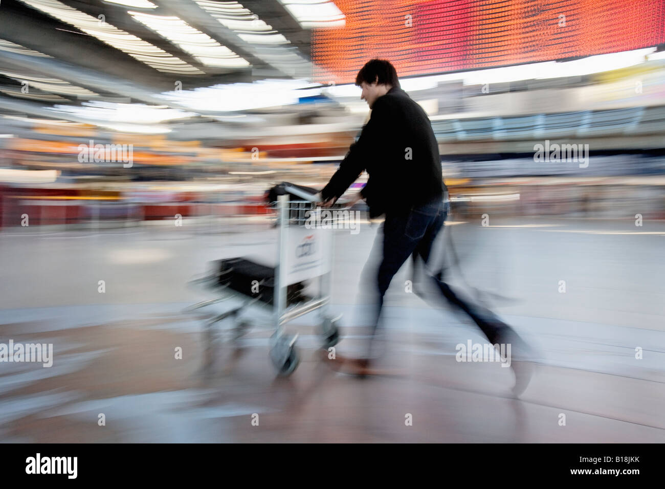 YOUNG MAN HURRYING AT THE AIRPORT Stock Photo - Alamy