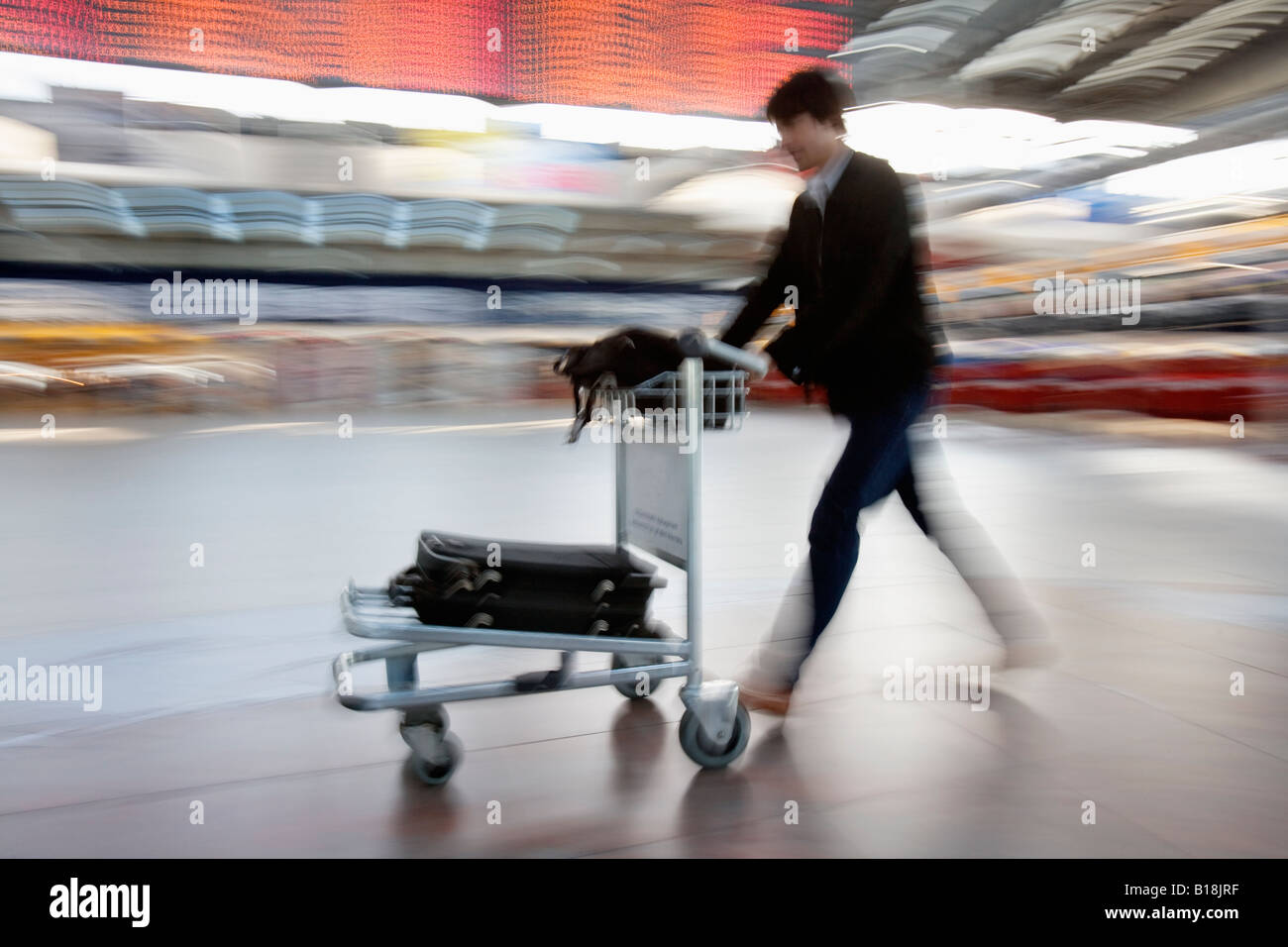YOUNG MAN HURRYING AT THE AIRPORT Stock Photo - Alamy