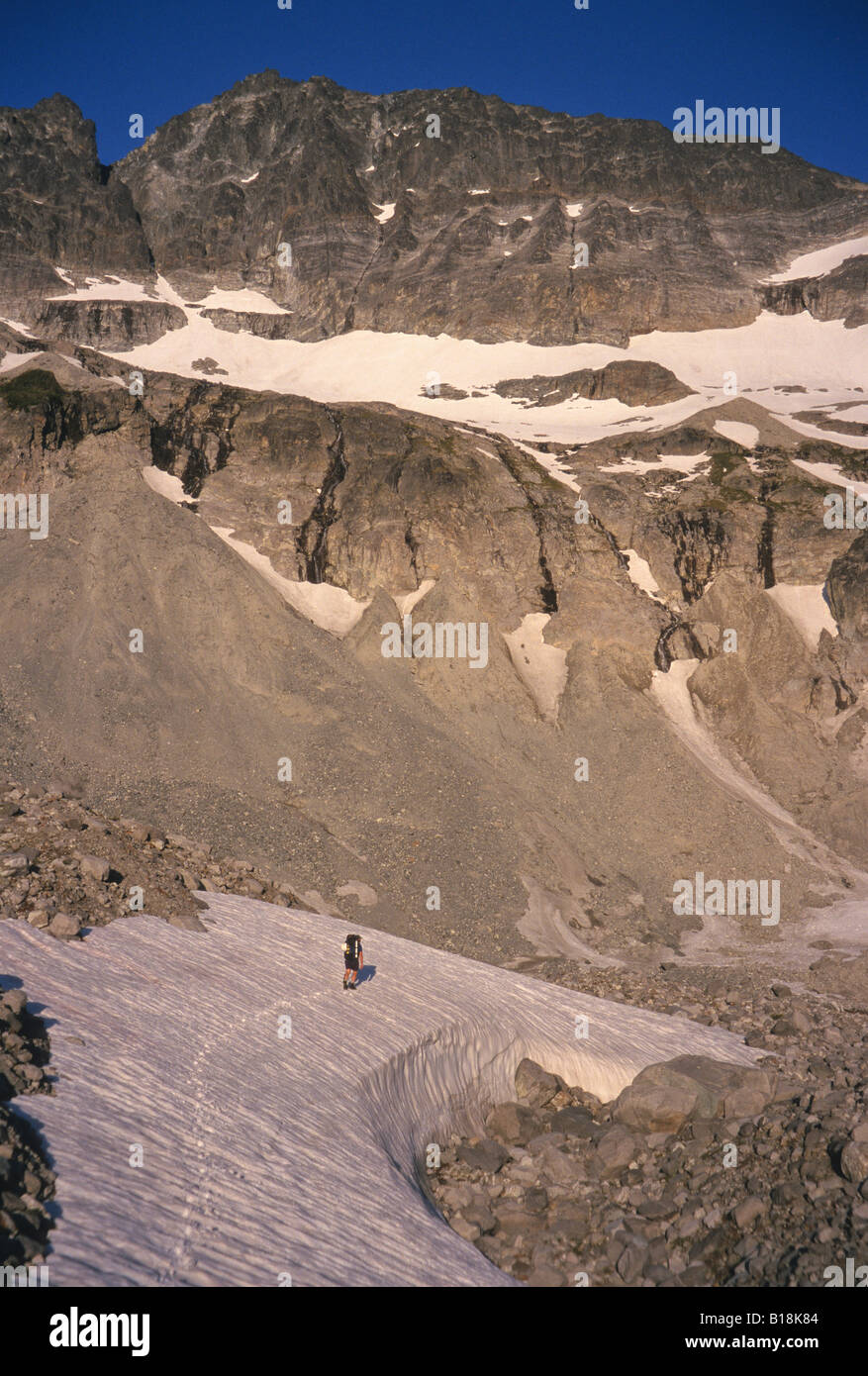Man heading for camp below Mt Redoubt Cascade Mountains Washington ...