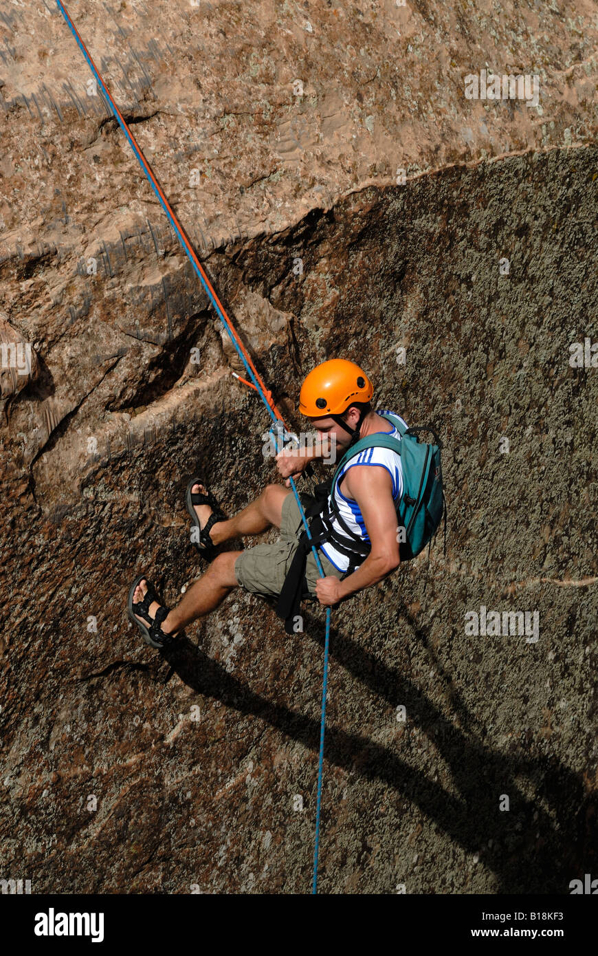 Tourist hanging on a rope while Canyoning in the area of the slick rock ...